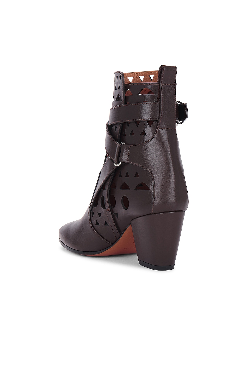 ALAÏA Perforated Ankle Boot in Marron Fonce | FWRD