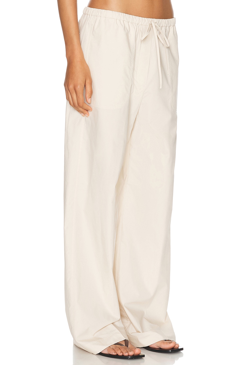 Toteme Cotton Drawstring Trousers in Stone | FWRD